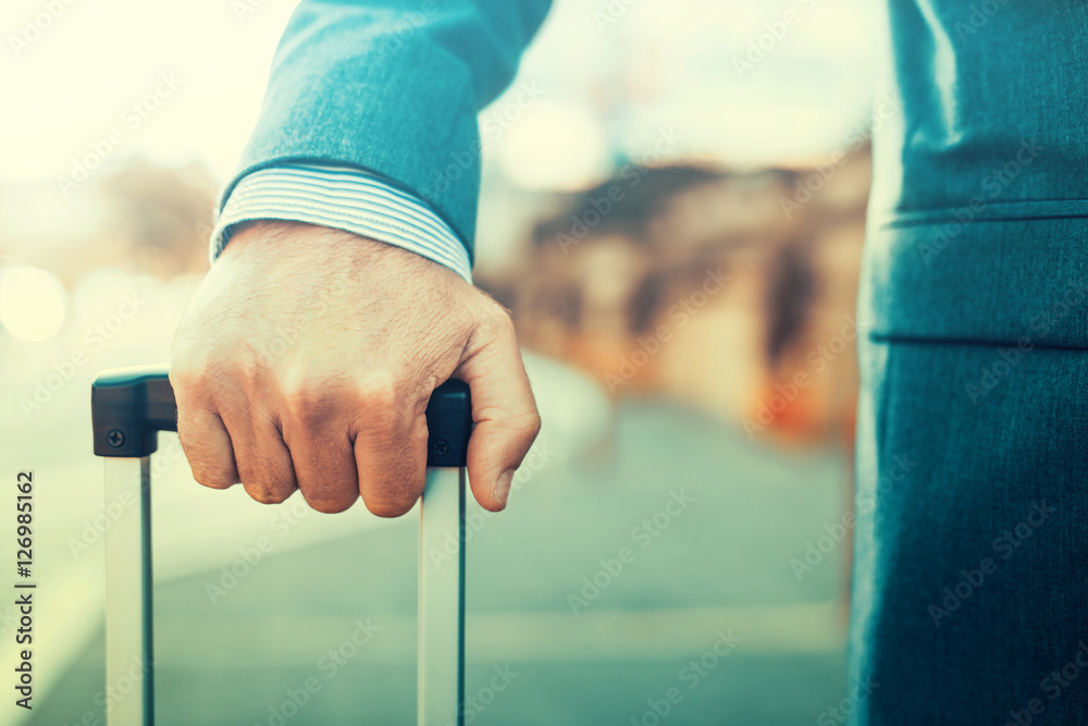 Man's hand with a suitcase Stock-Foto | Adobe Stock