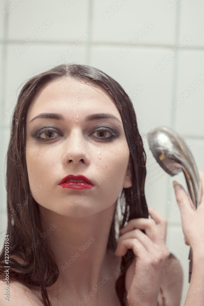 sad girl with shower in hand at bathroom Stock Photo | Adobe Stock