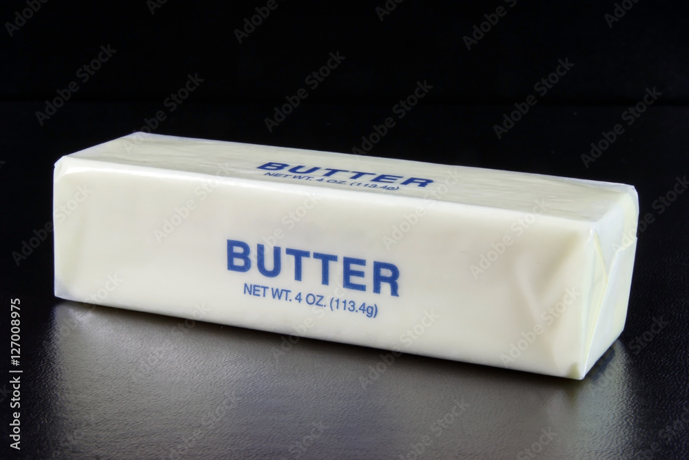Stick of butter. Black background. Horizontal. Stock Photo | Adobe Stock