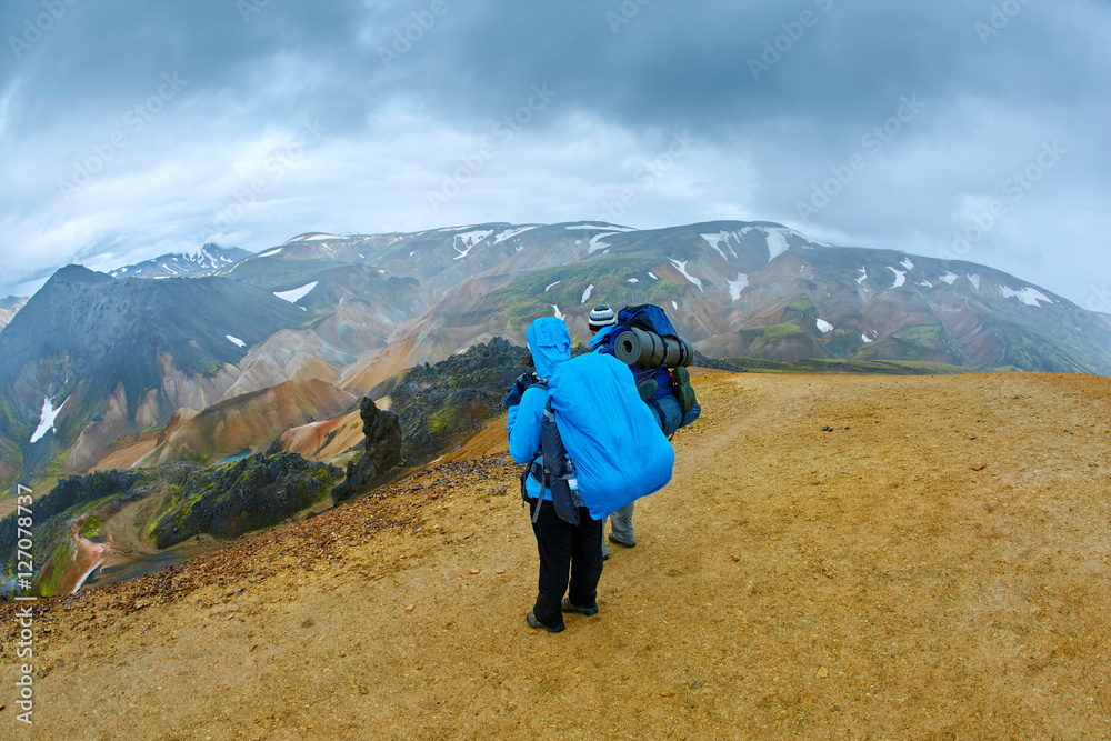female hiker on the trail in the Islandic mountains. Trek in National ...