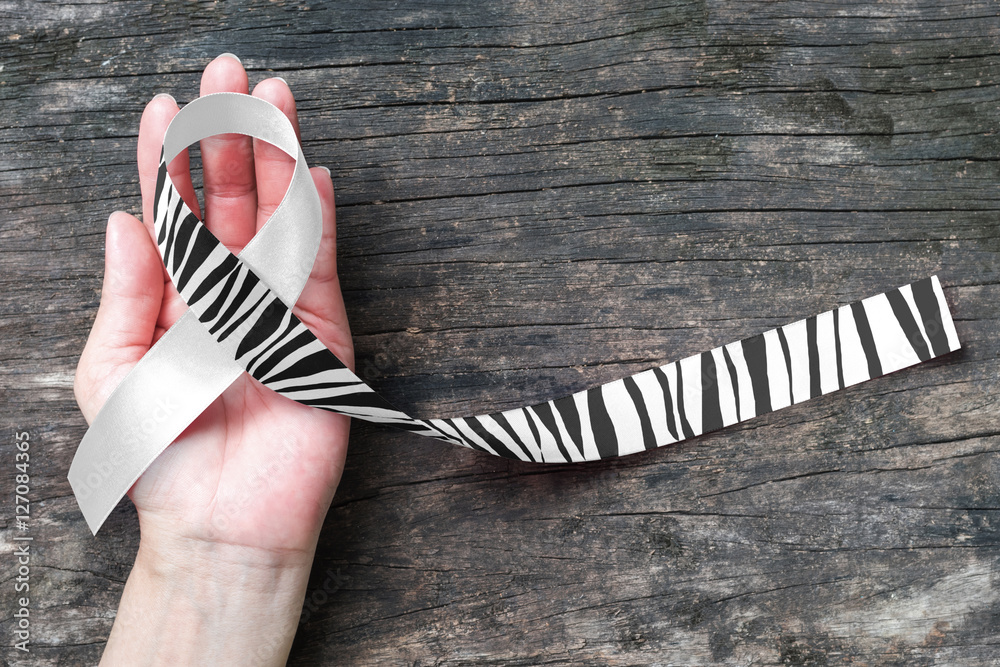 Carcinoid Cancer Awareness ribbon zebra stripe pattern on helping hand ...