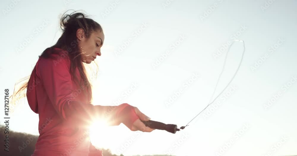 Close-up of hands an jumping women on the jump rope. Athlete girl ...