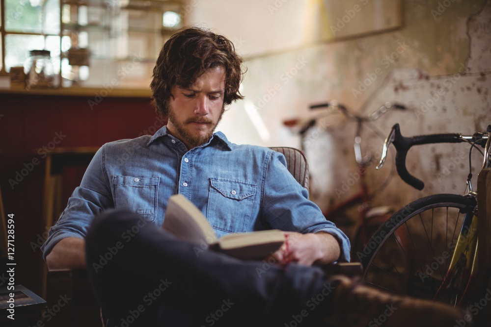 Mechanic reading book Stock Photo | Adobe Stock