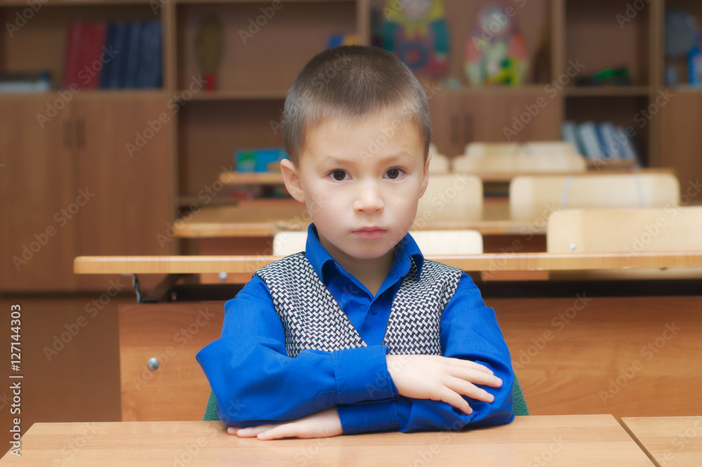 School boy sitting in classroom Stock-Foto | Adobe Stock