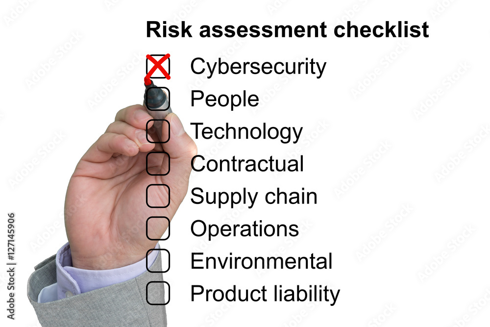 Hand crosses off first item of a risk assessment checklist Stock Photo ...