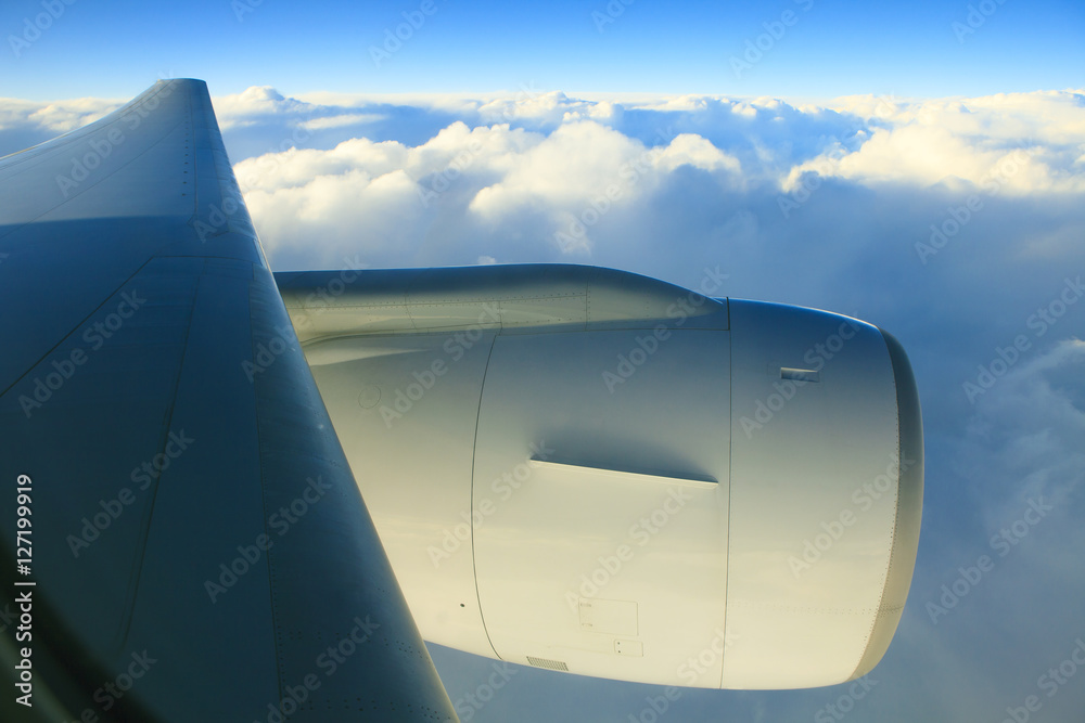 air plane engine and wing floating over white cloud and blue sky Stock ...