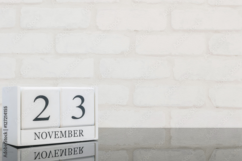 Closeup white wooden calendar with black 23 november word on black ...