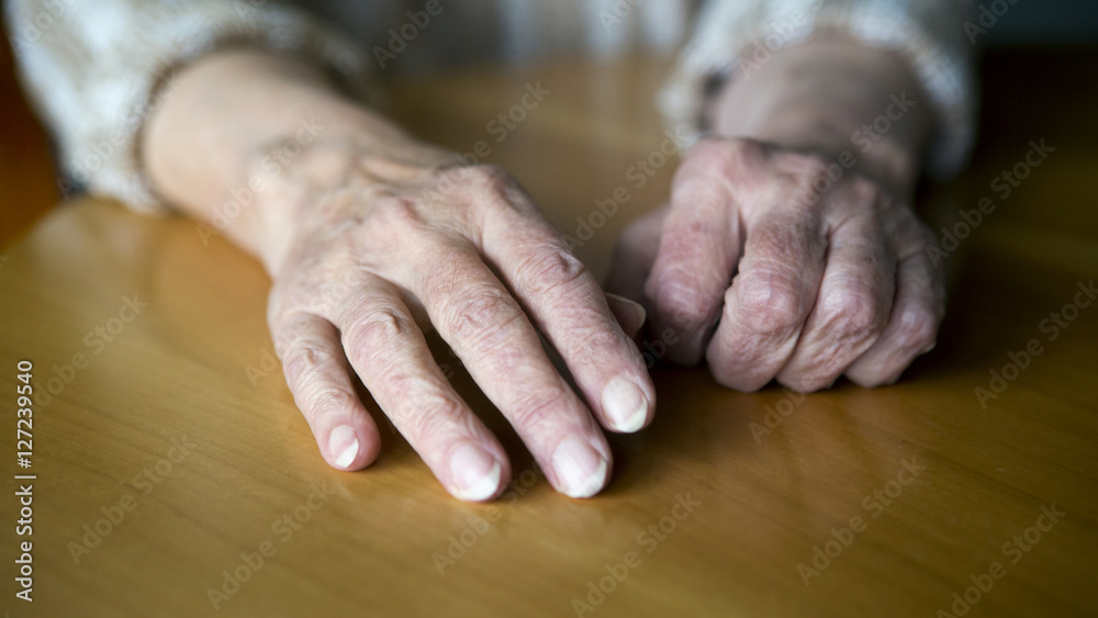 closeup of old female hands on table Stock Photo | Adobe Stock