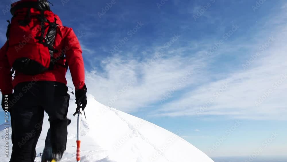 Mountaineer arrive at the top of a snowy peak in winter season ...