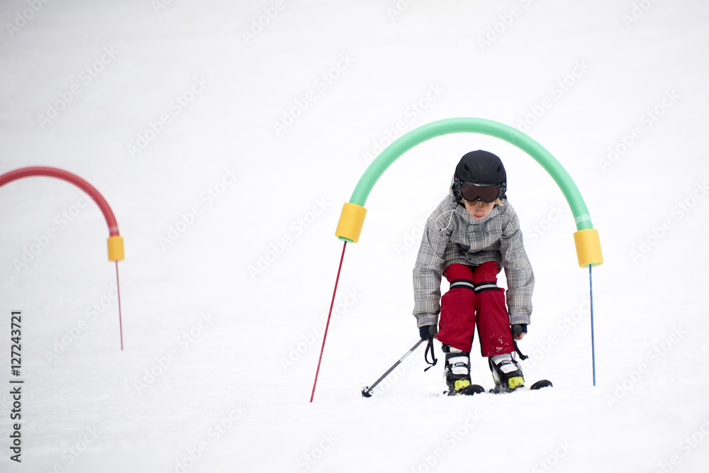 Child boy skiing in mountains. Active teenager kid with safety helmet ...