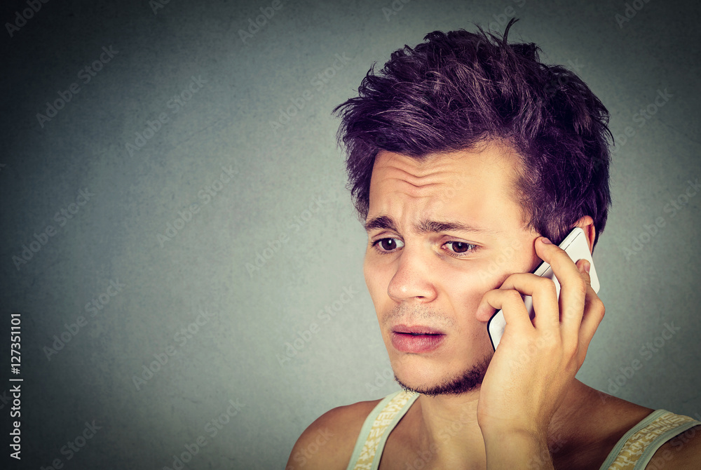 worried young man talking on phone to someone looking upset Stock Photo ...