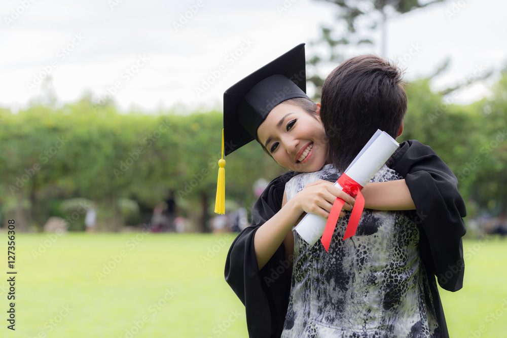 Asian female student and family hug celebrating graduation Stock Photo ...