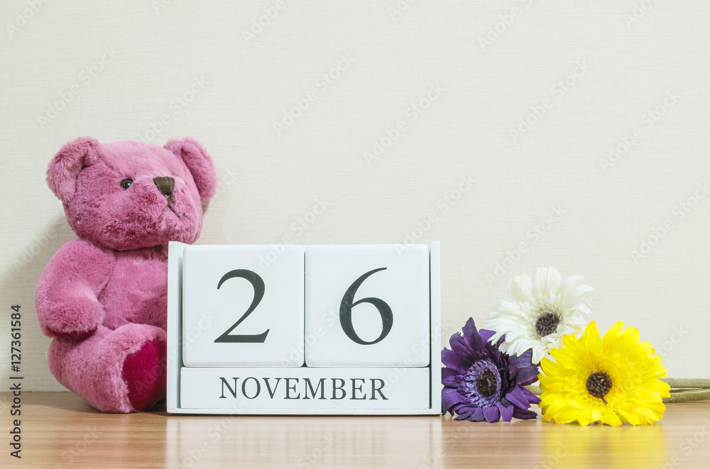 Closeup surface white wooden calendar with black 26 november word on ...