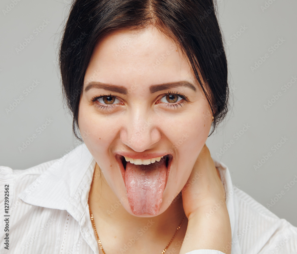 Woman sticking her tongue out Stock Photo | Adobe Stock
