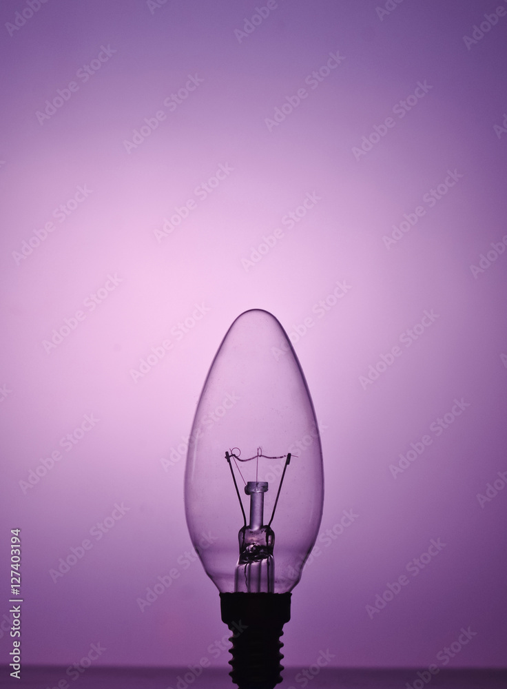Incandescent light bulb on purple background. Stock Photo | Adobe Stock