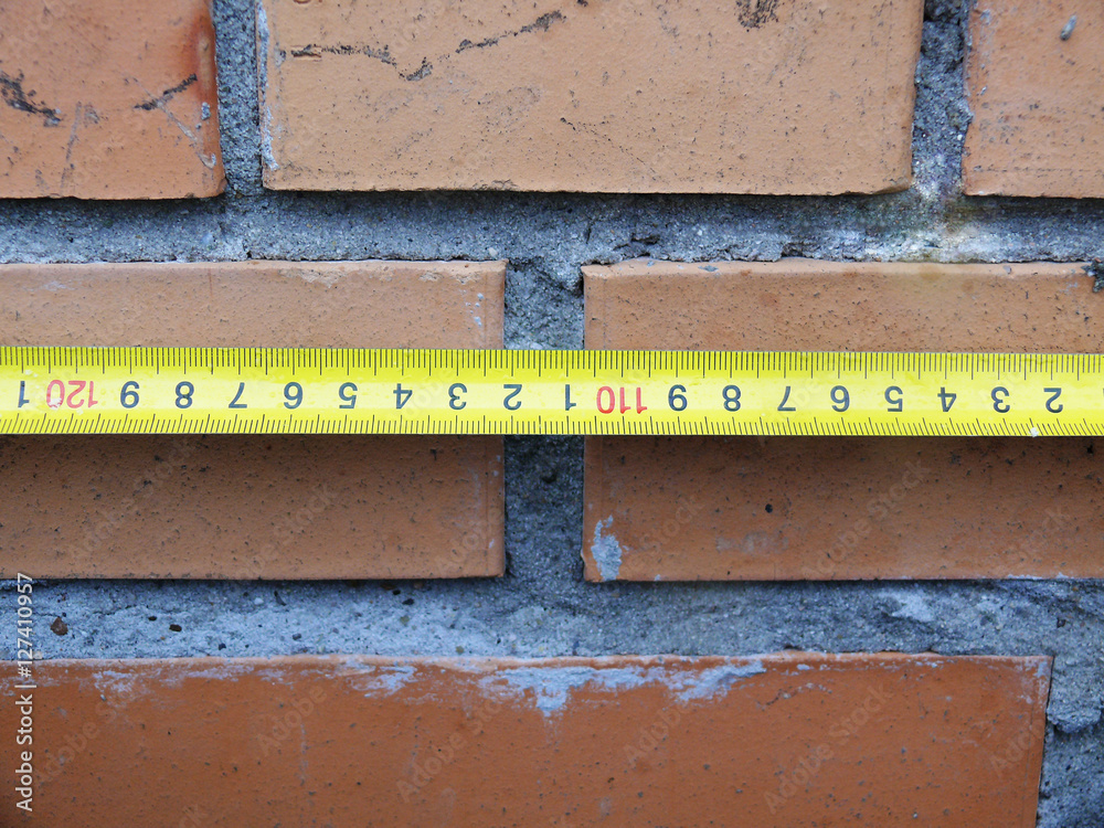 measuring the size of a brick wall on a building roof foto de Stock ...