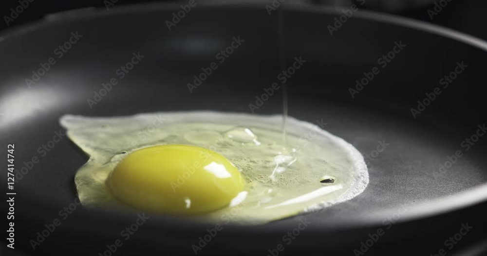 egg falling in frying pan in slow motion Stock Video | Adobe Stock