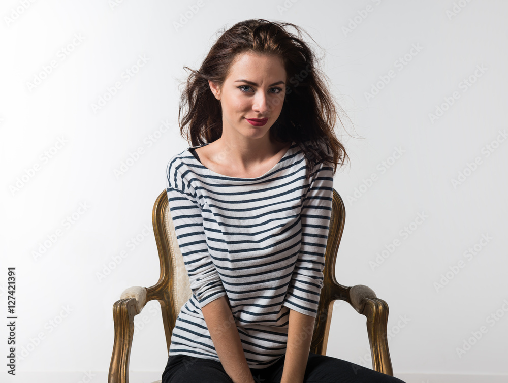 Beautiful model woman posing in studio with a vintage armchair Stock ...