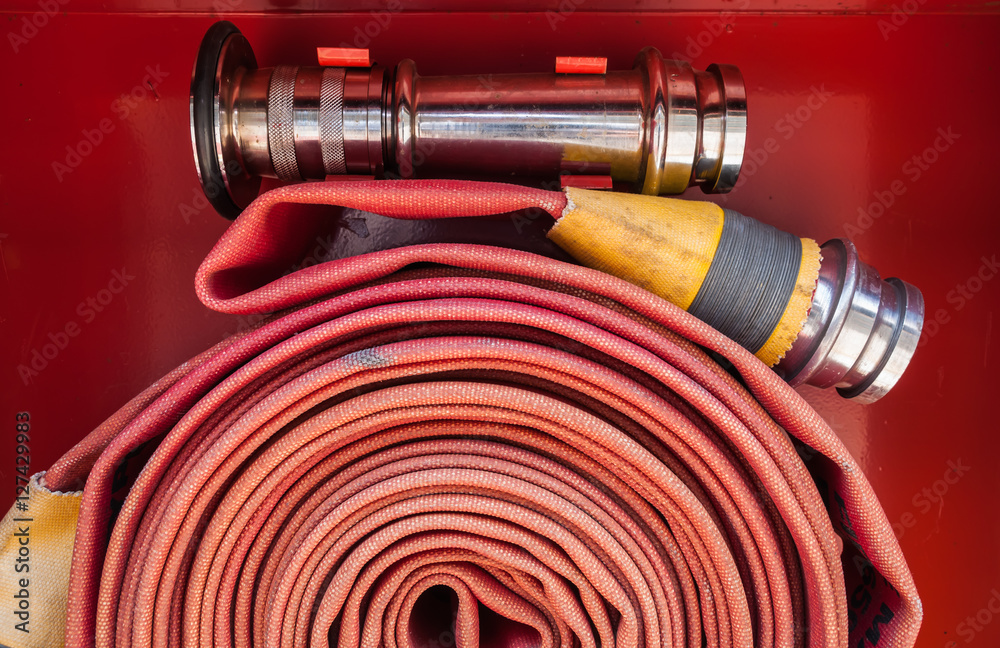 Red fire hose Stock Photo | Adobe Stock