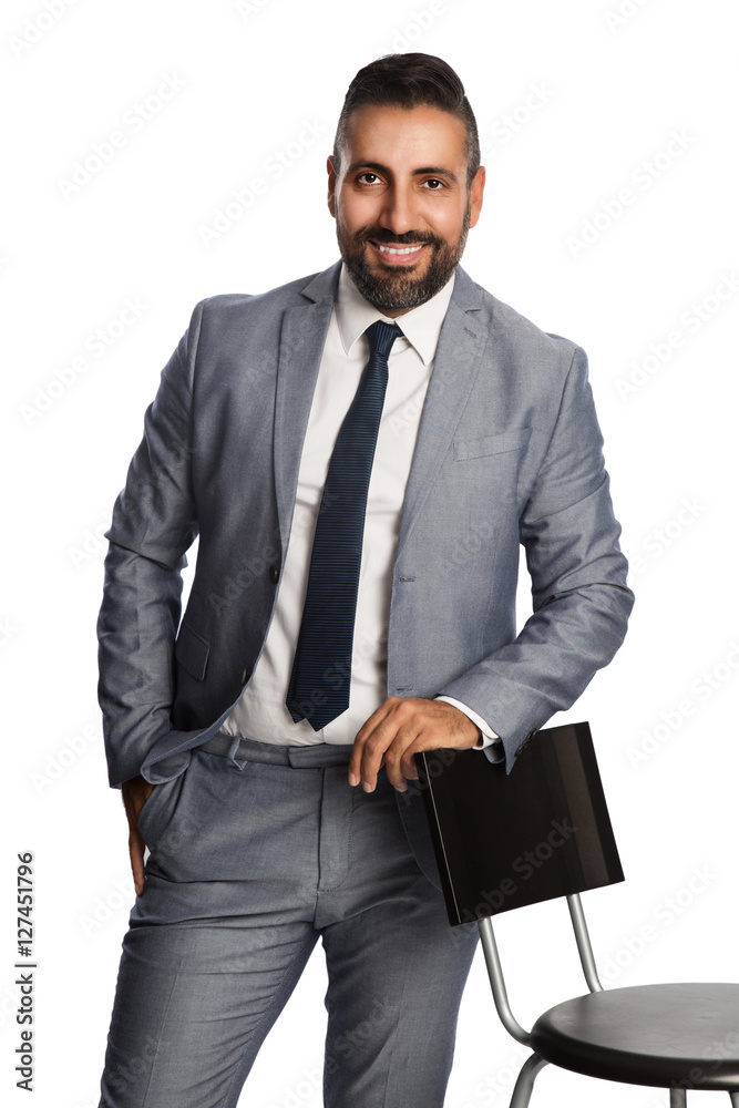 Attractive businessman in a grey suit, white shirt and blue tie with a ...