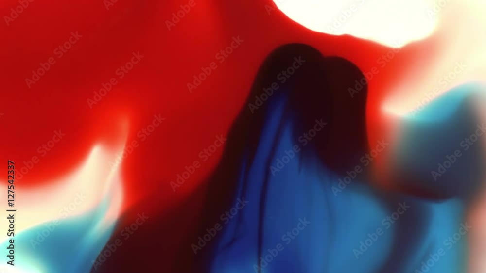 Blue and Red Ink mixing together over a pure white background ...