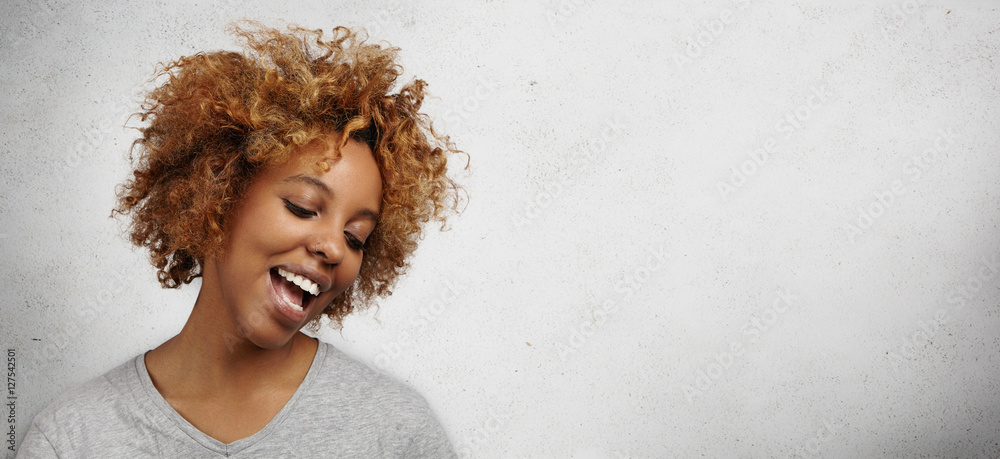 Cute young dark-skinned female with stylish haircut and facial piercing ...