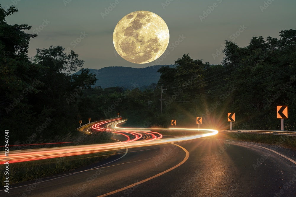 Car Light trail sparkly on Long macadamized S-curvy road with trees and ...