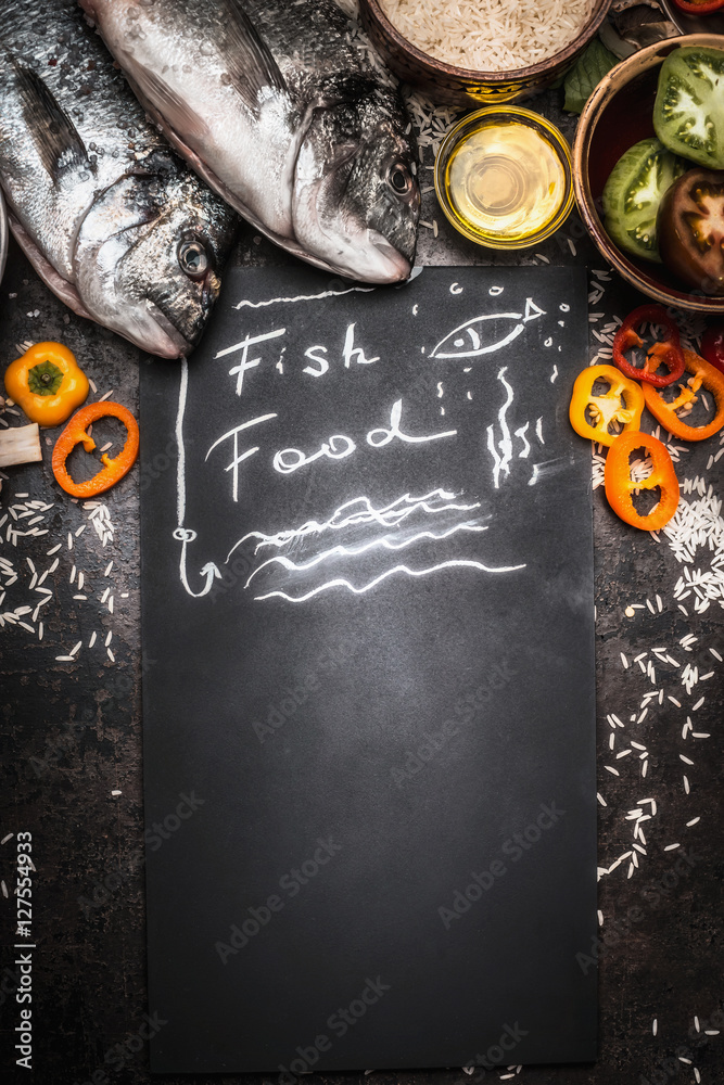 Fish food on black chalkboard with raw dorado fishes and healthy ...
