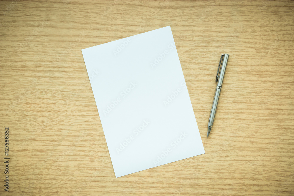 Workplace background with empty white note paper and pen on wood desk ...