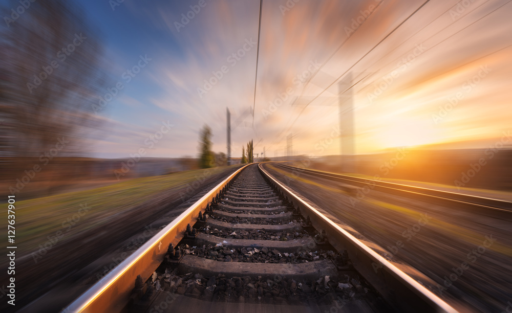 Railroad in motion at sunset. Railway station with motion blur effect ...