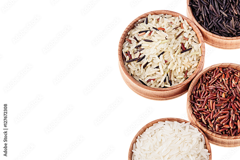 Red, black and white rice close-up in wood bowls on white background ...