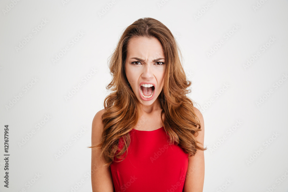 Angry irritated young woman standing and shouting Stock Photo | Adobe Stock