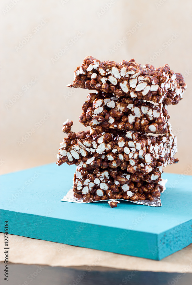 chocolate crisps from puffed rice on the blue stand on a light ...