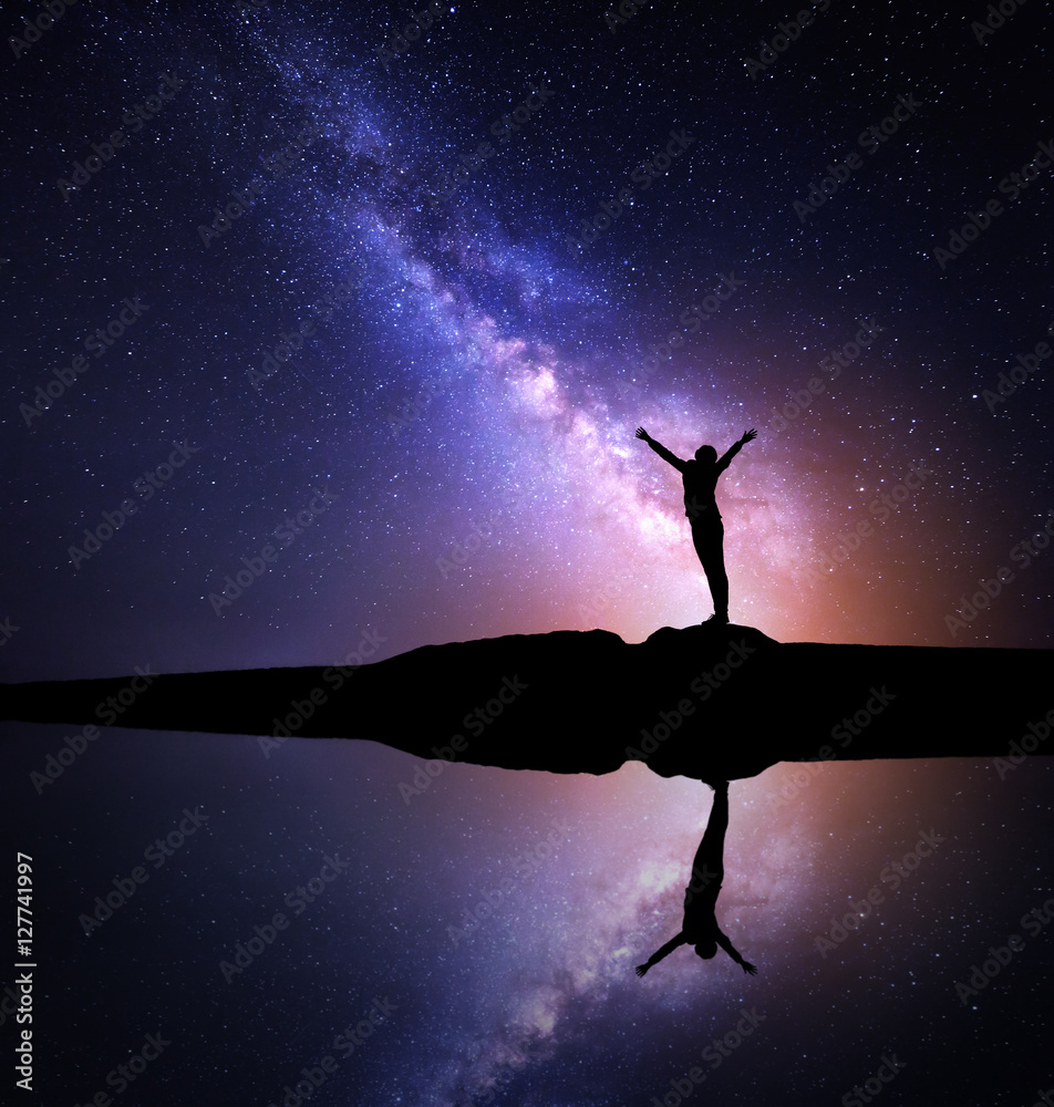Milky Way. Night starry sky and silhouette of a standing woman with ...