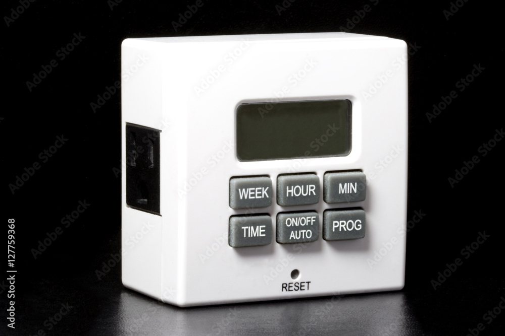 Front and side view of white plug-in timer for electrical items. Black ...