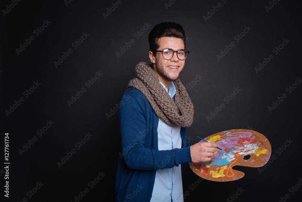 Positive artist holding color palette Stock Photo | Adobe Stock