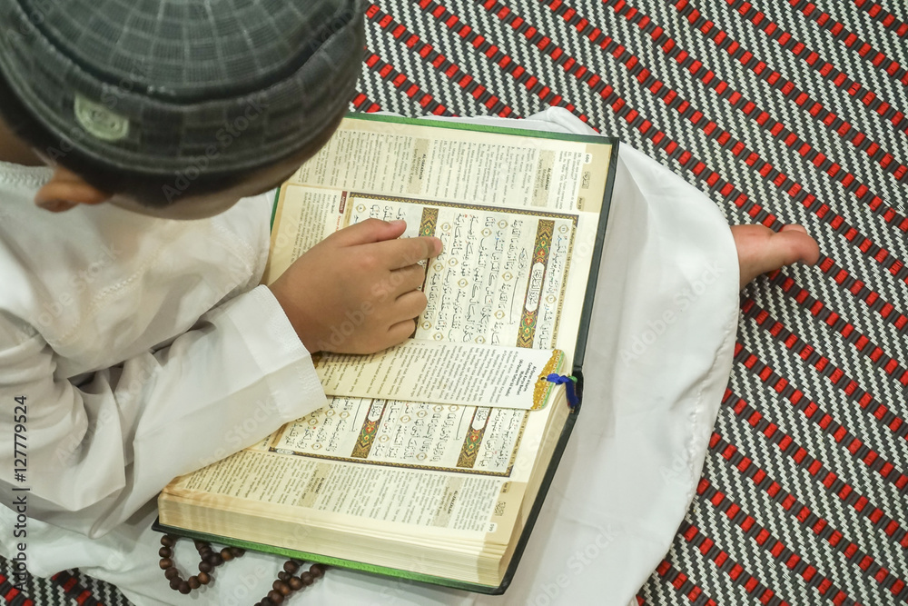 Boy reading Quran. Stock Photo | Adobe Stock