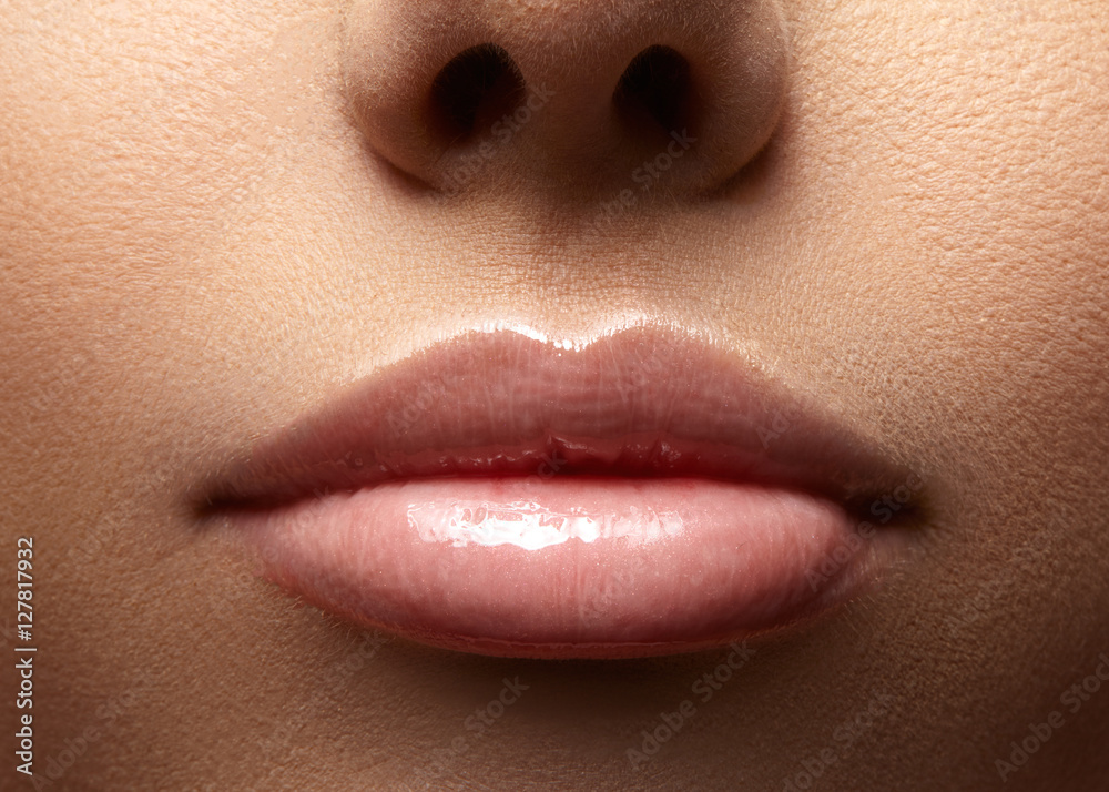 Face part. Beautiful female lips with natural makeup, clean skin. Macro ...