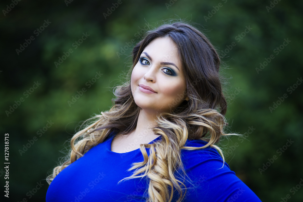 Young happy smiling plus size model in blue dress outdoors, xxl woman ...