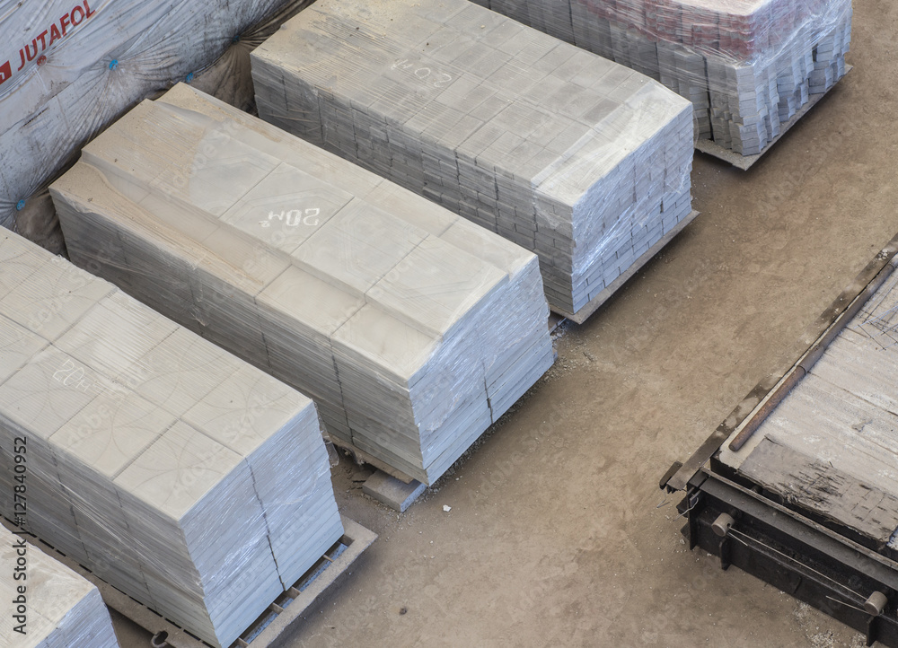 Stack of precast reinforced concrete slabs in a house-building factory ...
