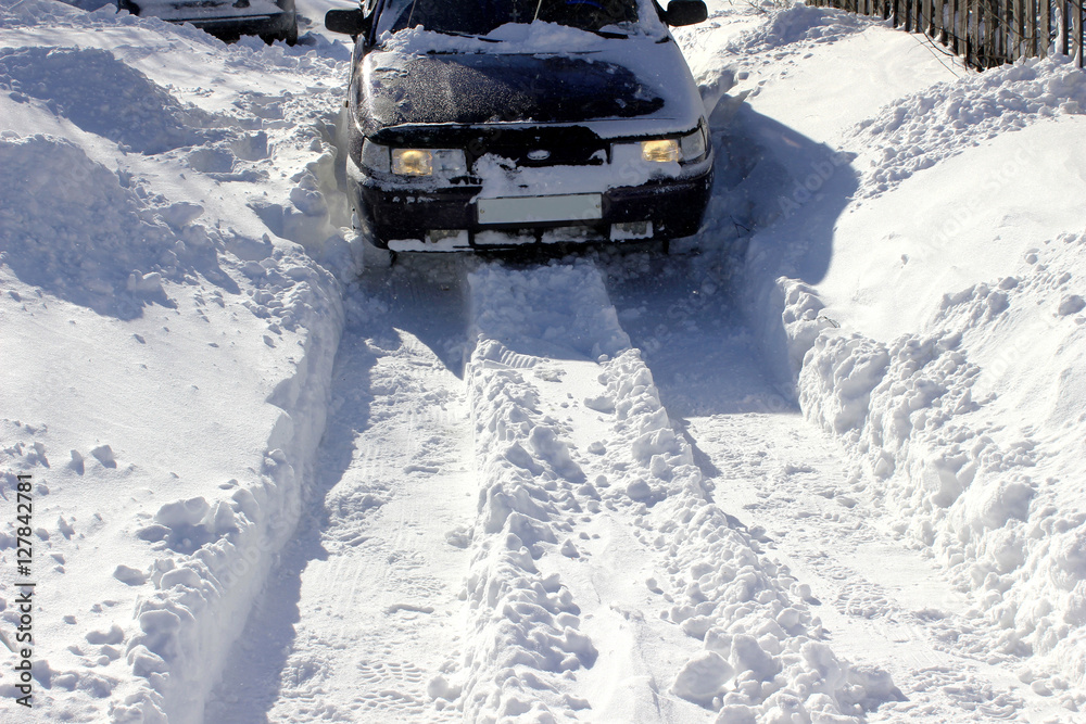 Deep drifts of snow. after a heavy snowfall. A vehicle stuck in the ...