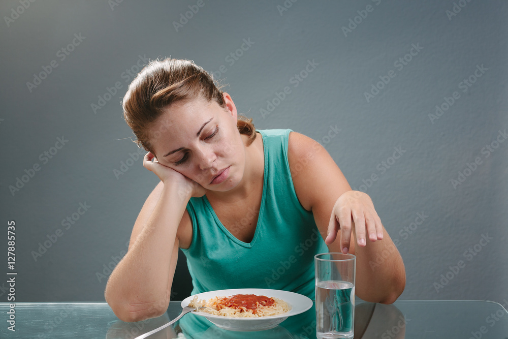 Portrait of woman with no appetite in front of the meal. Concept of ...
