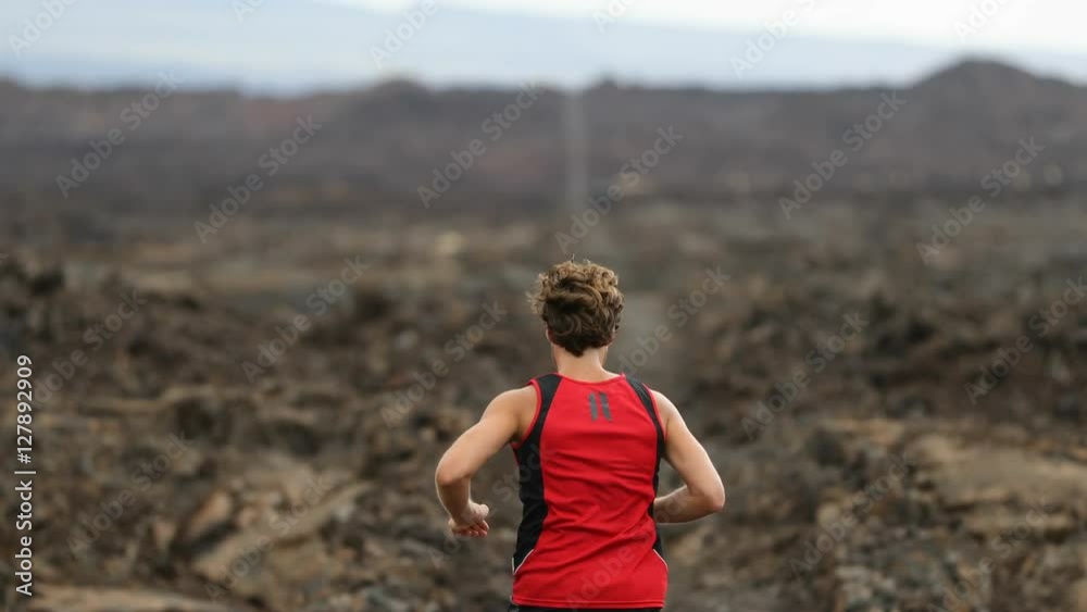 Trail runner man running cross-country run training outside for ...