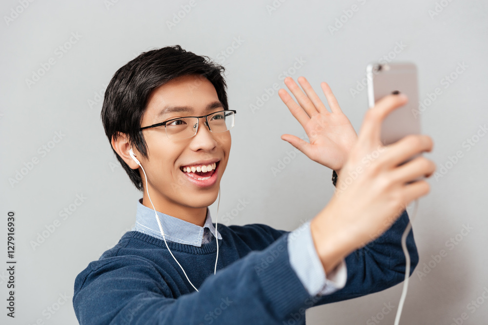 Asian man waving in phone Stock Photo | Adobe Stock