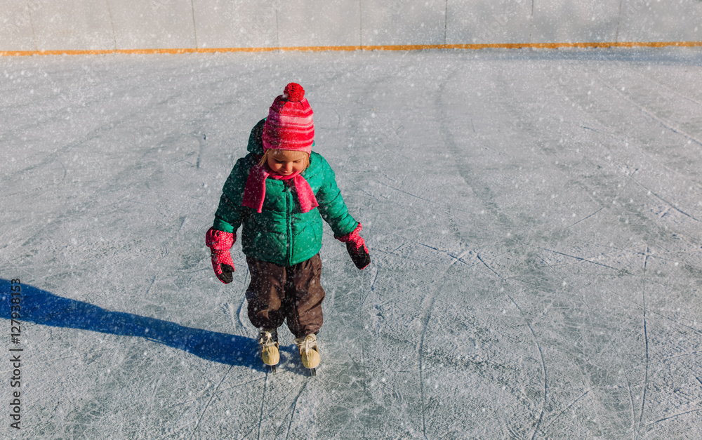 cute little girl learning to skate in winter Stock Photo | Adobe Stock