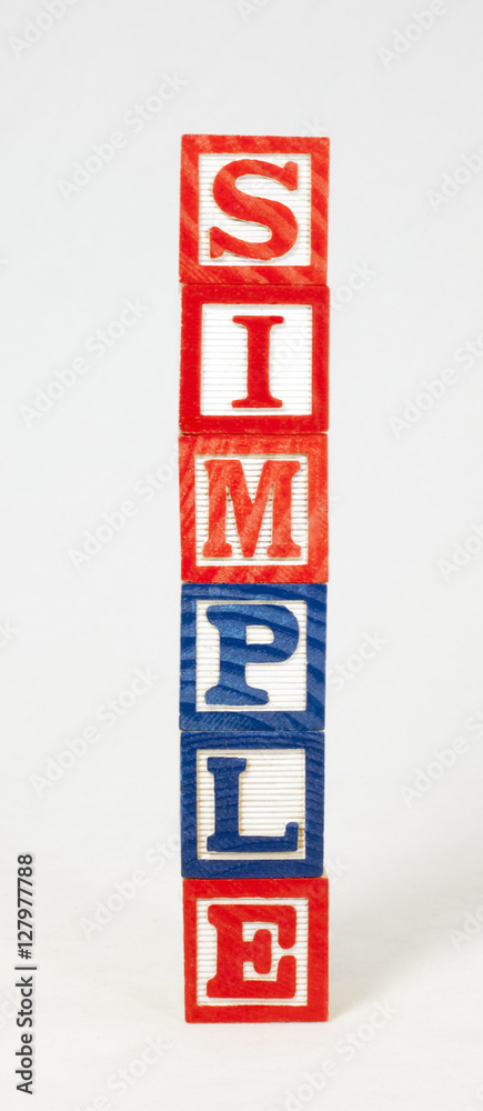 The word 'simple' in stacked red and blue toy blocks. Vertical. Stock ...