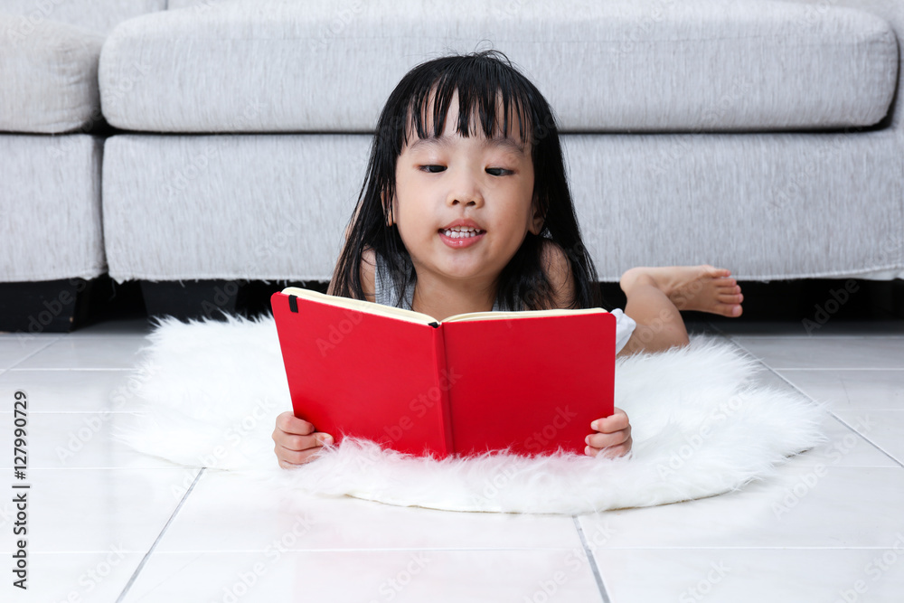 Asian Chinese little girl reading book on the floor Stock Photo | Adobe ...