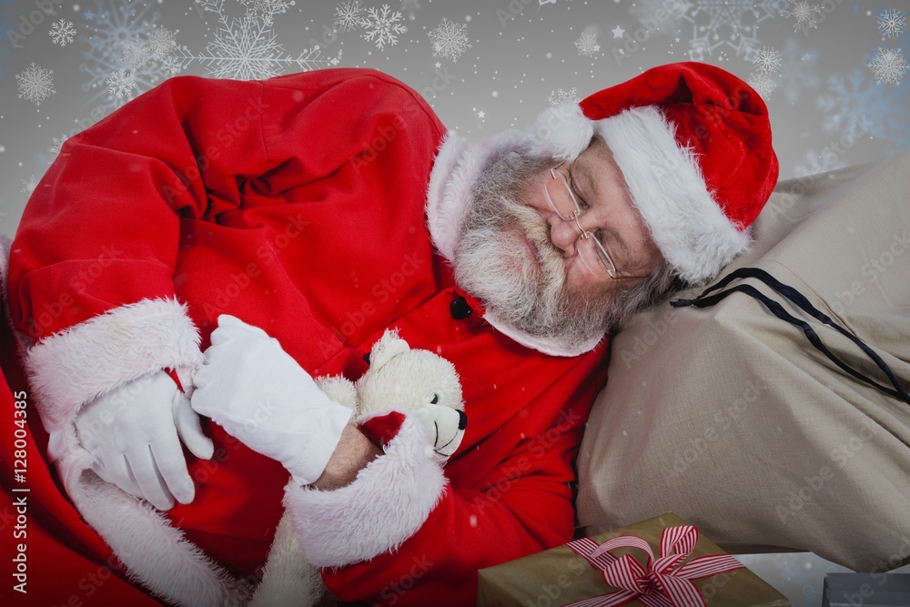 Composite image of tired santa claus sleeping beside christmas p Stock ...