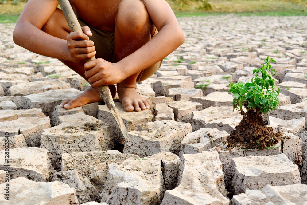 Sad a boy sitting on dry ground .concept drought and hope Stock Photo ...