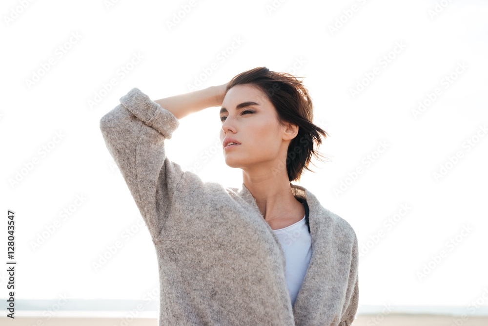 Beautiful relaxed young woman standing and posing on seashore Stock ...